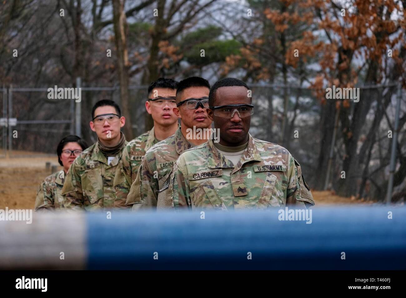 Five Soldiers prepare to ascend the weaver obstacle as part of the ...