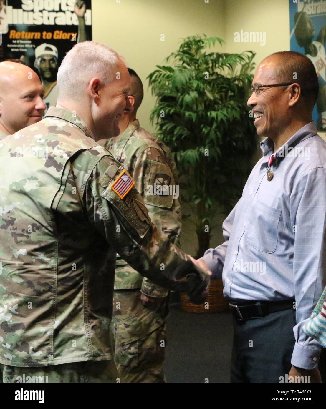 Maj. Gen. John Evans, commander of U.S. Army Cadet Command, presents Romeo Miguel with the ...