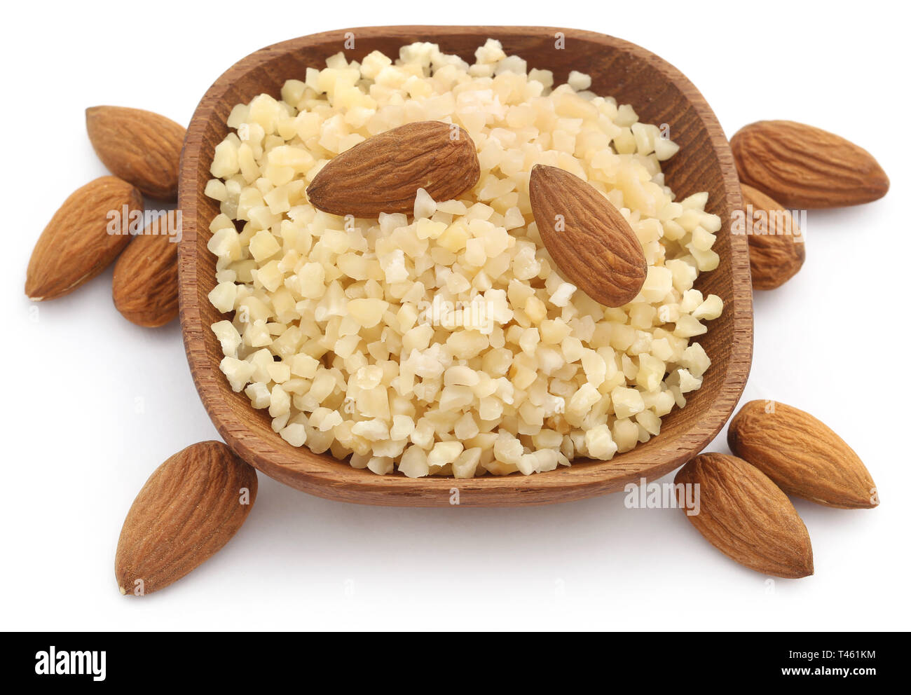 Small pieces of chopped almonds with whole ones in wooden bowl Stock ...