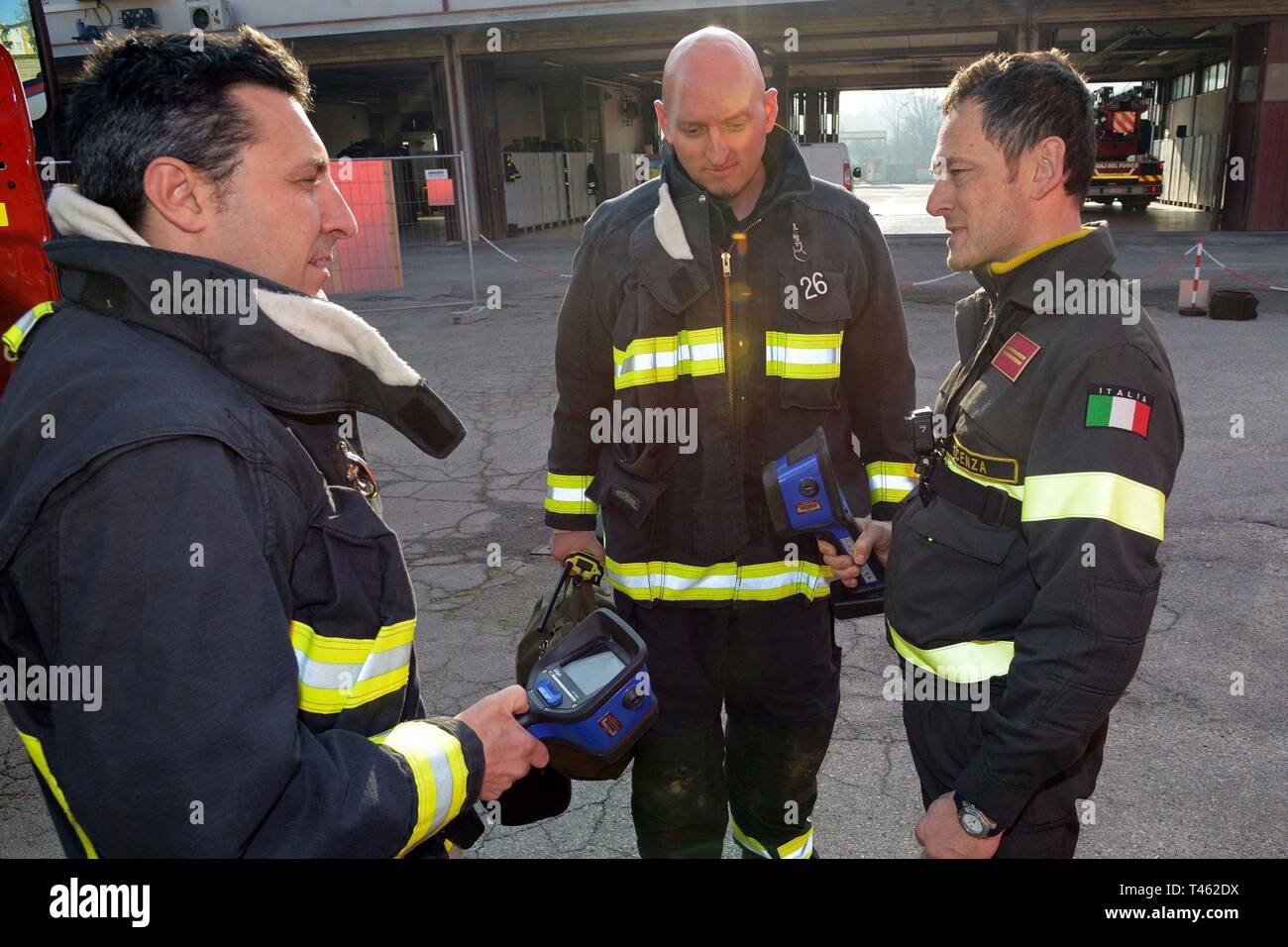 U.S. Army Garrison Italy firefighters and a Italian firefighter discuss ...