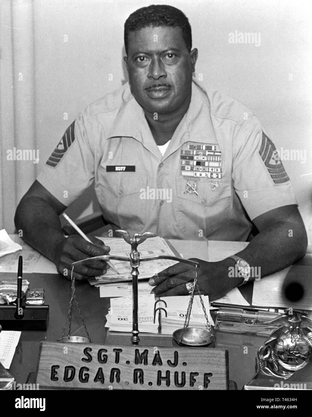 U.S. Marine Corps Sgt. Maj. Edgar R. Huff sits at his desk in this ...