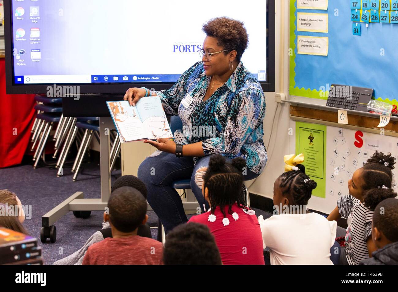 Marlo Grandberry, an employee at Norfolk Naval Shipyard, reads to ...