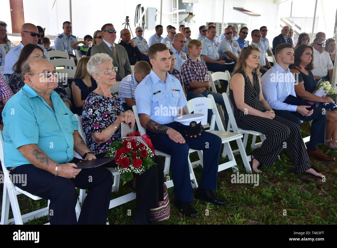 Master Chief Buddy Gilbert's family sits in the audience during a ...