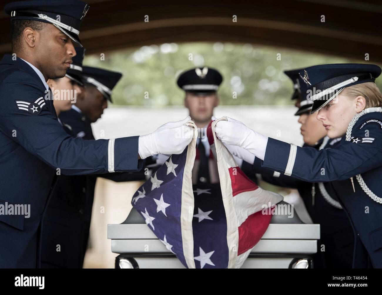 Airmen begin the flag-folding portion of the Team Eglin Honor Guard ...
