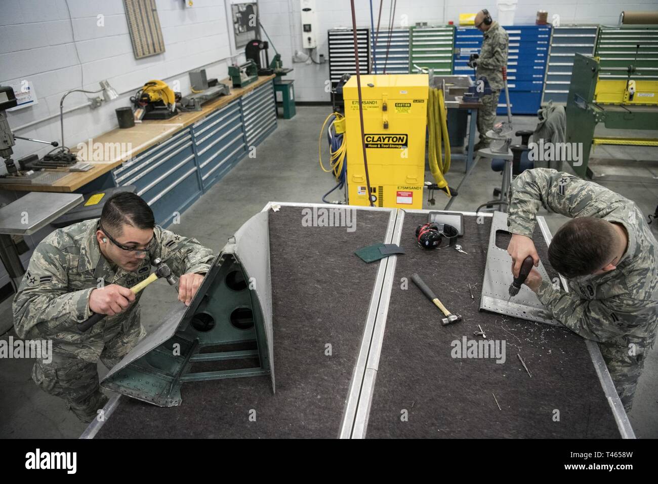 104th Maintenance Group structural maintainers work on a F-15 Eagle ...