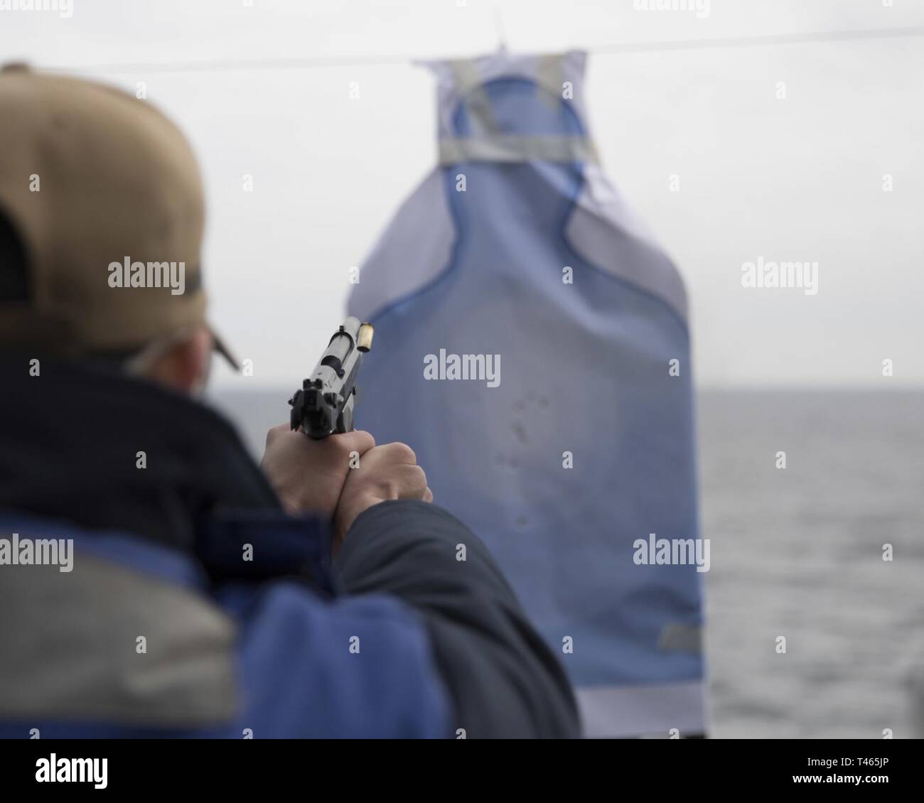 OCEAN (Mar. 3, 2019) Ensign Jesse Garcia fires a M-9 service pistol ...