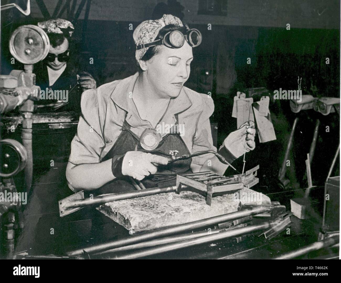Employees of the Glenn L. Martin Company weld aircraft parts in the ...