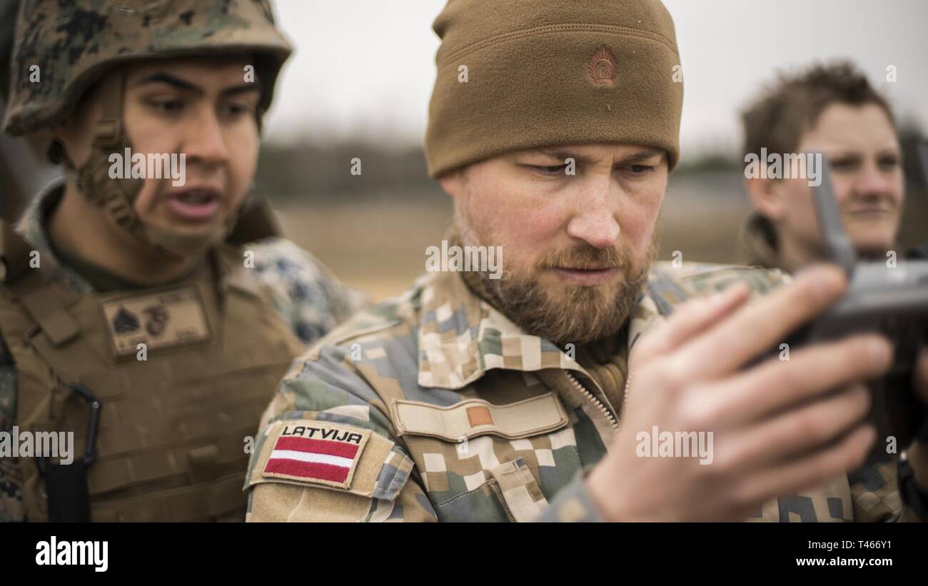 Latvian Army Staff Sgt. Gatis Indrevics, a combat cameraman with the Latvian Army, shows drone ...