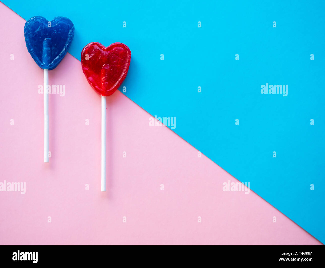 Red and blue lollipops on a pink and blue background Stock Photo - Alamy