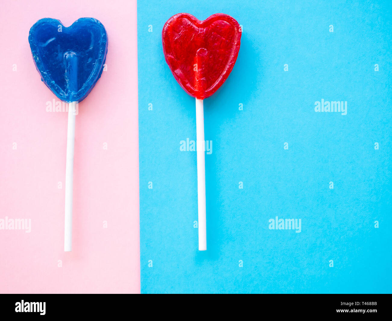 Red and blue lollipops on a pink and blue background Stock Photo - Alamy