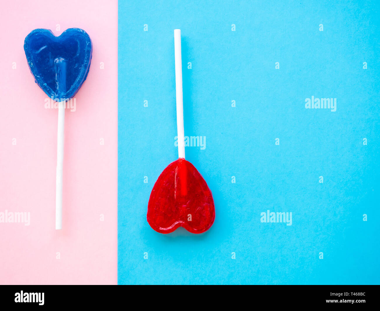 Red and blue lollipops on a pink and blue background Stock Photo - Alamy
