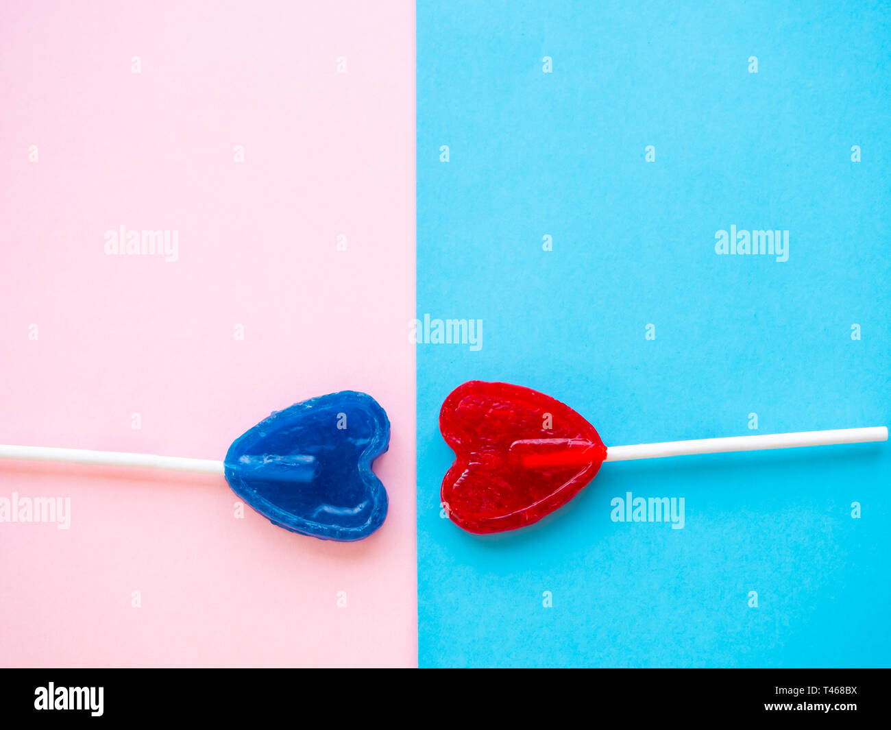 Red and blue lollipops on a pink and blue background Stock Photo - Alamy