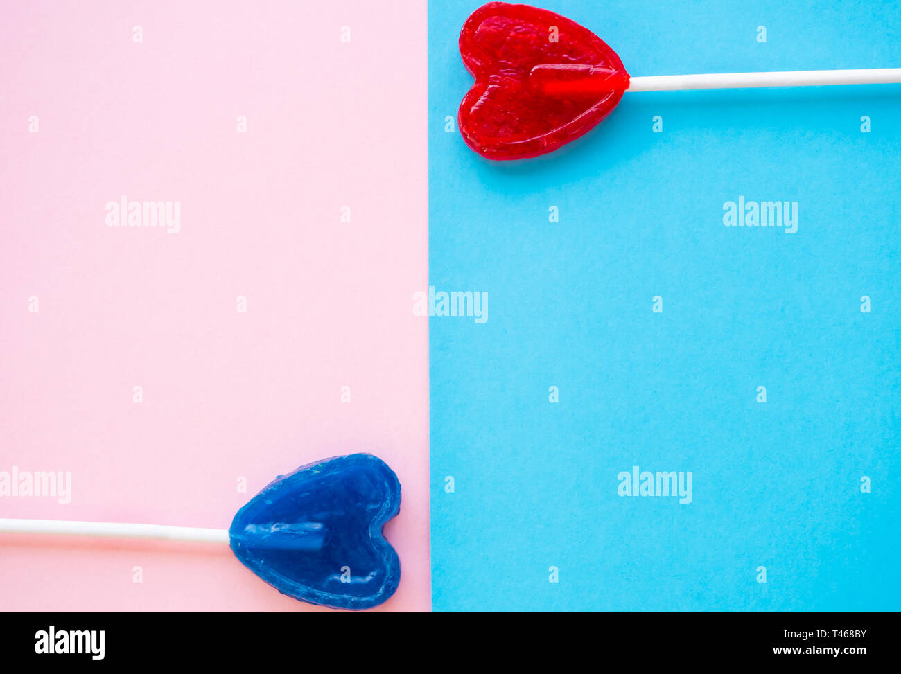 Red and blue lollipops on a pink and blue background Stock Photo - Alamy