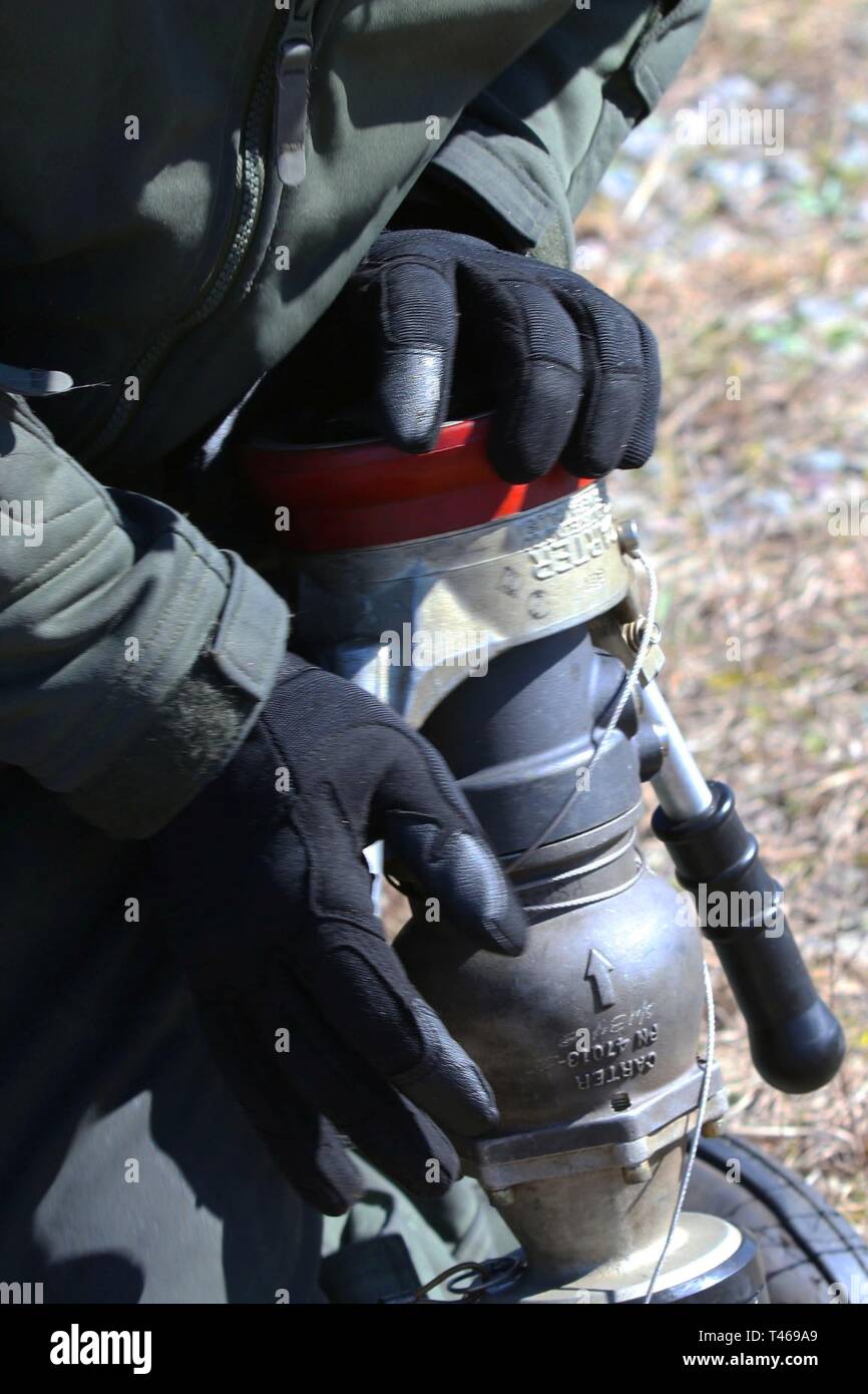 A U.S. Marine with HMH-366, assembles fuel hoses prior to refilling a ...