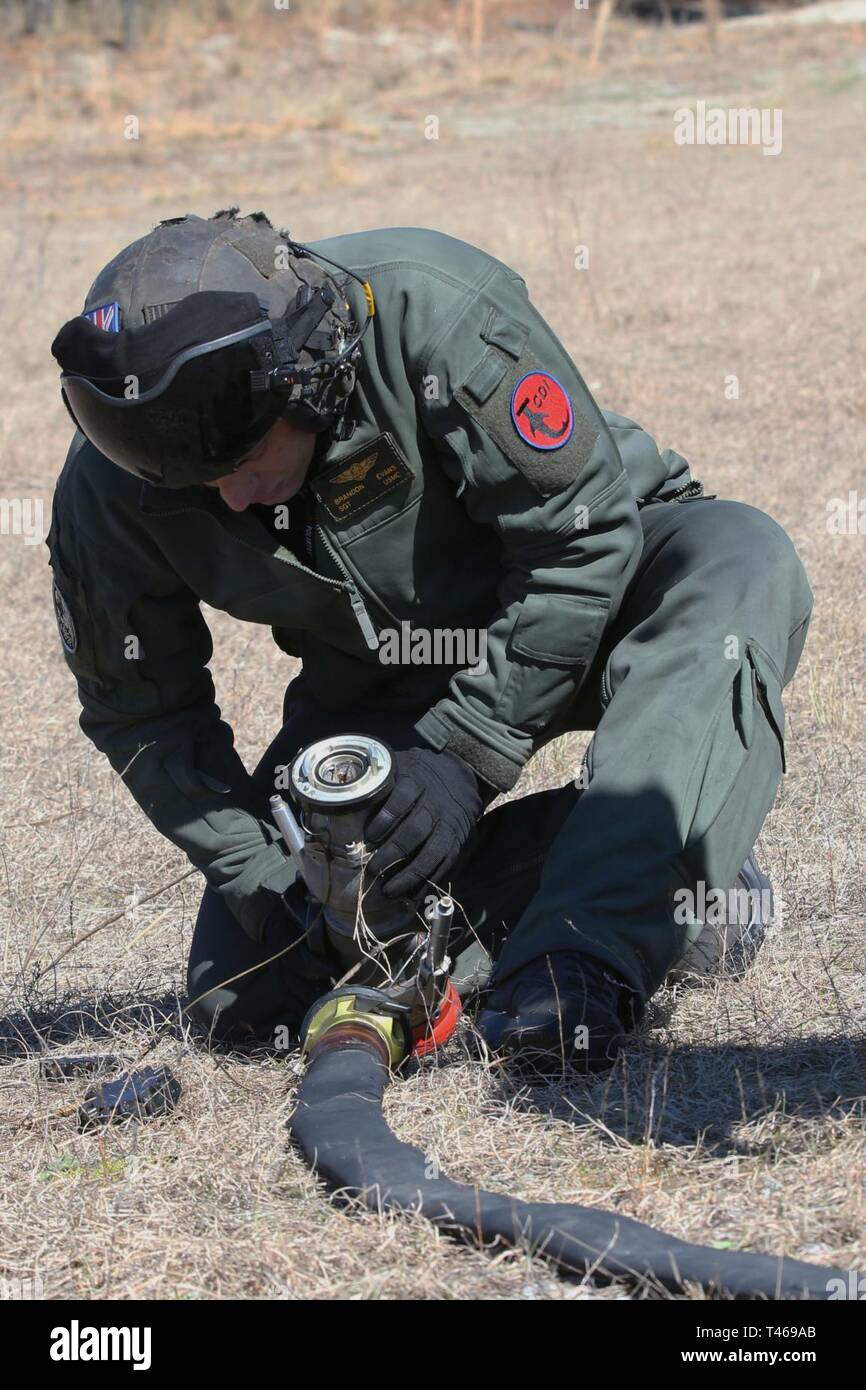 A U.S. Marine with HMH-366, assembles fuel hoses prior to refilling a ...