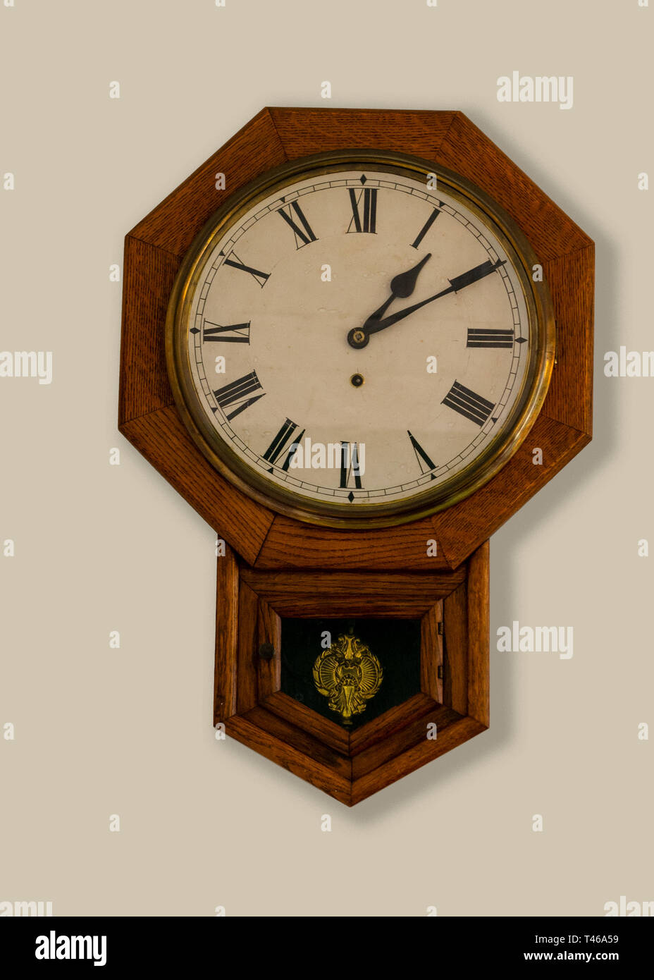 Eight corners wooden vintage clock on tan wall - octagon Stock Photo ...