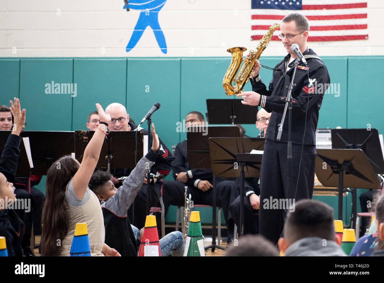 Musician Second Class Leeland Rothrock demonstrates the alto saxophone ...
