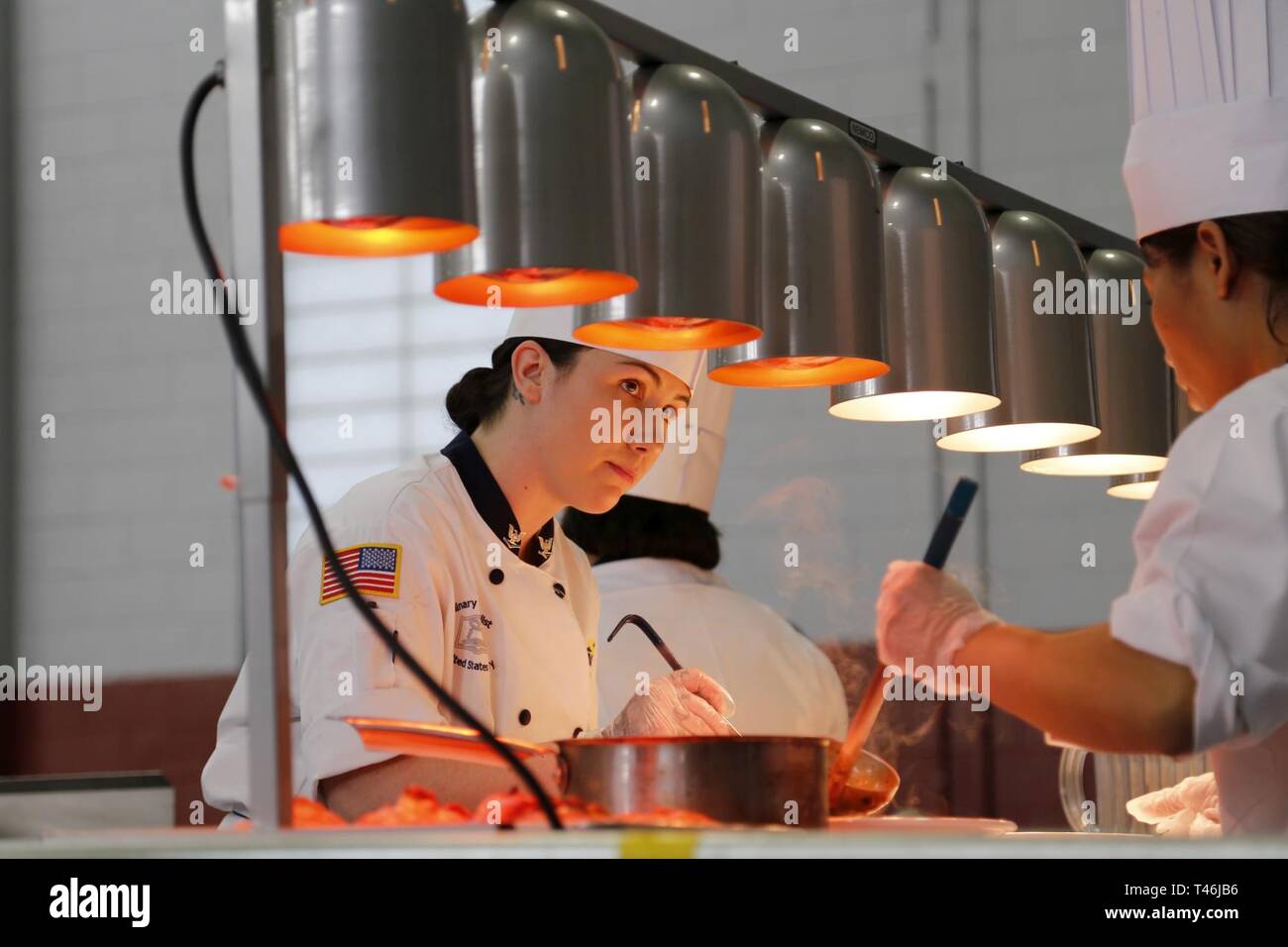 U.S. Navy Culinary Specialist 3rd Class Kelsie Aday prepares plates for ...