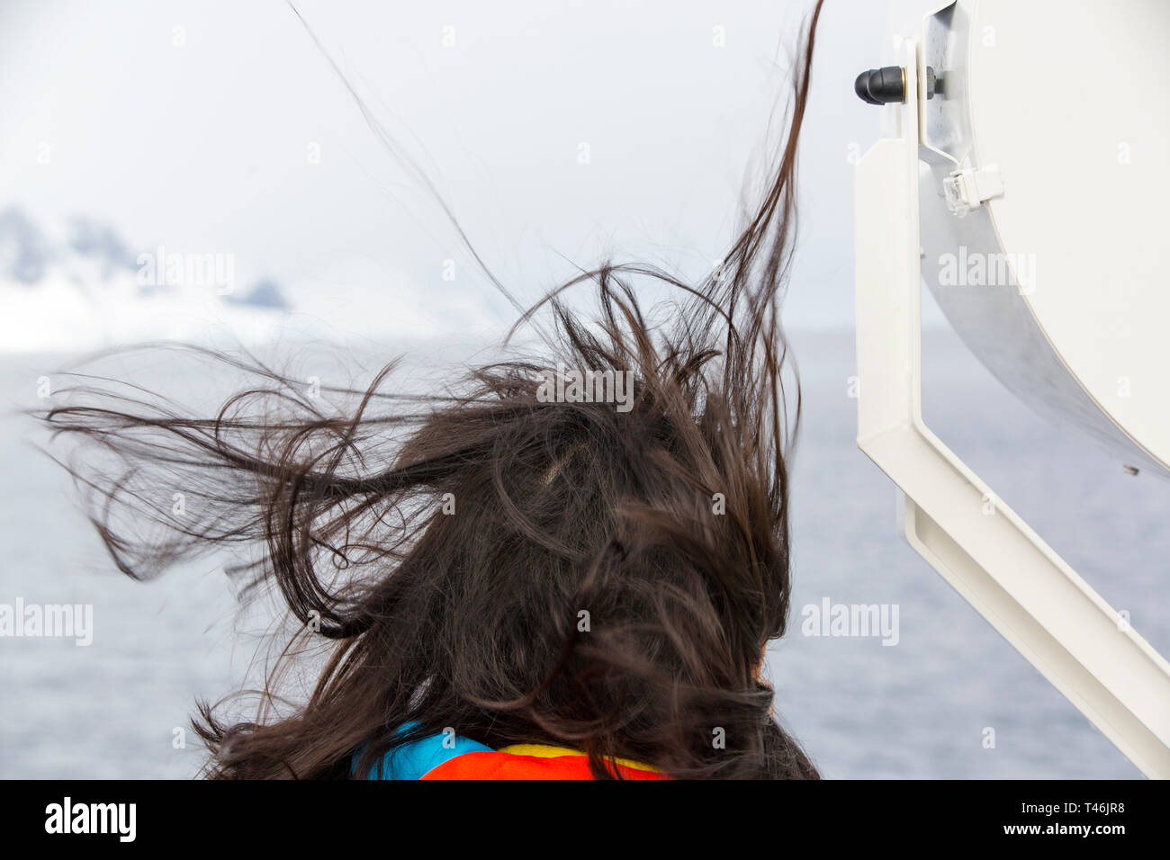 A Chinese child on an Antarctic cruise ship with her hair blowing in ...