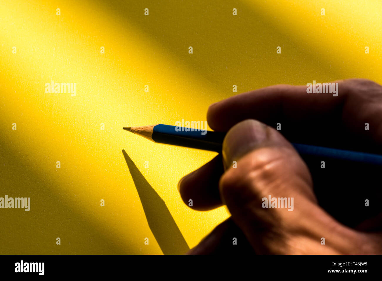 Human's hand holding pencil to write on the paper in shadow Stock Photo ...
