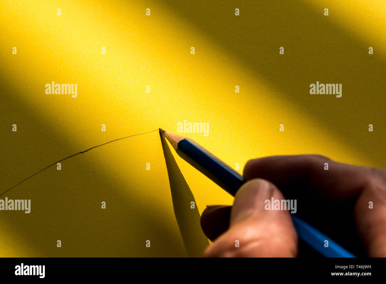 Human's hand holding pencil to write on the paper in shadow Stock Photo ...