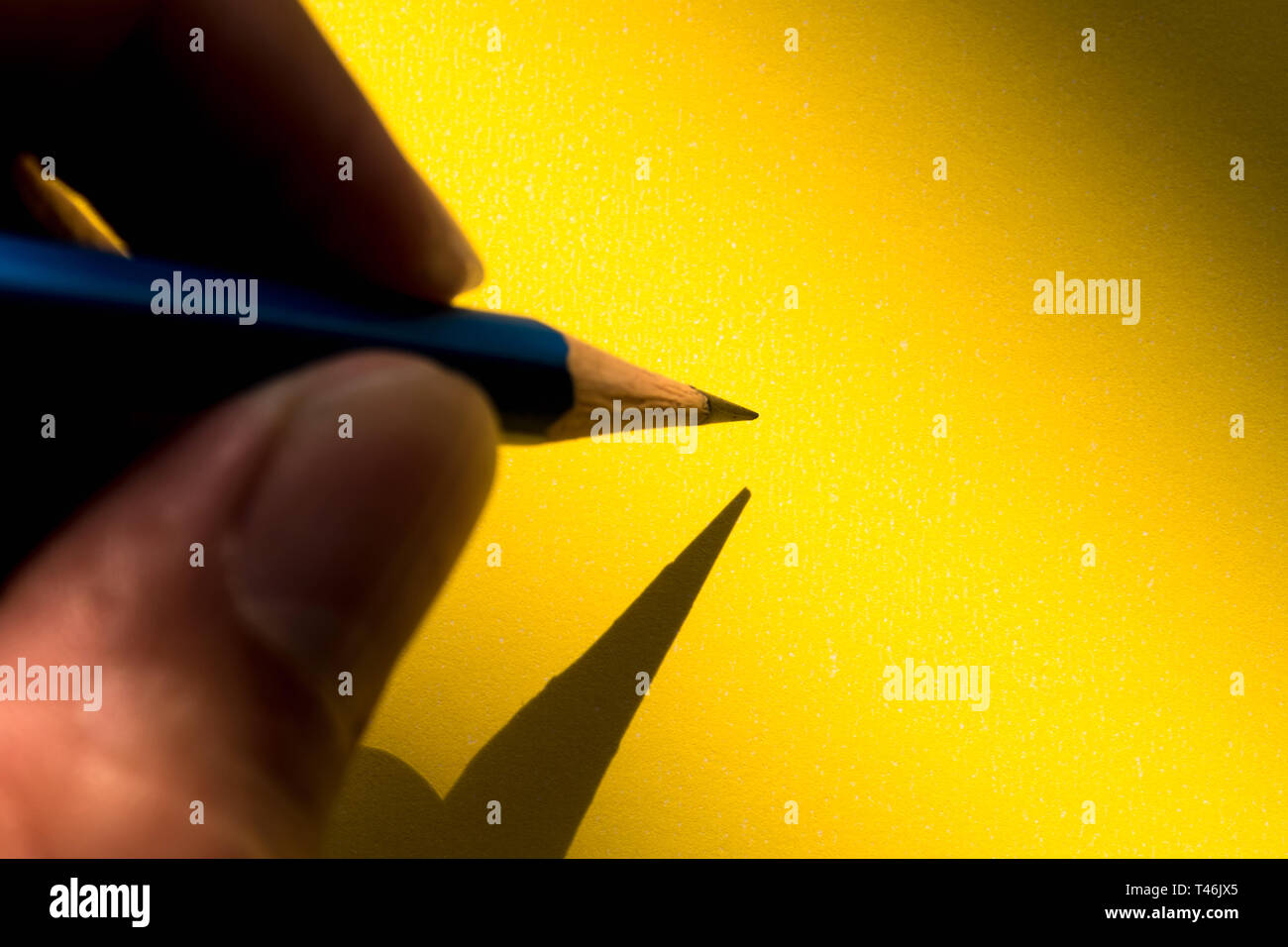 Human's hand holding pencil to write on the paper in shadow Stock Photo ...