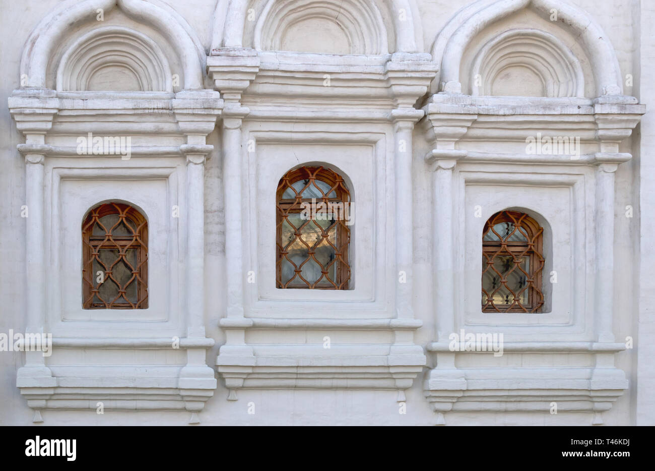 close up of small antique medieval windows design on white wall Stock ...