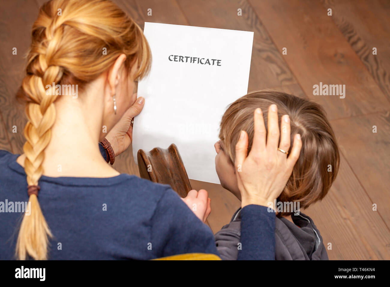 Mother comforting son despite the bad school certificate Stock Photo ...