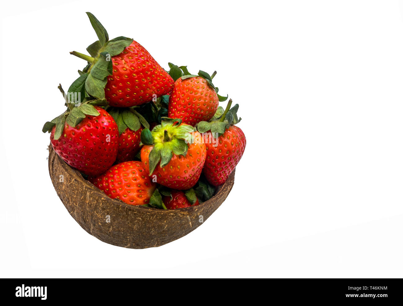 Fresh strawberries in a coconut shell on white background Stock Photo ...