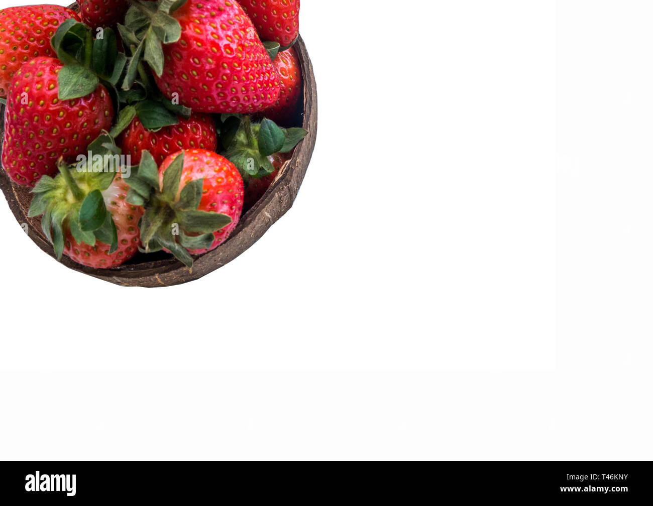 Fresh strawberries in a coconut shell on white background Stock Photo ...