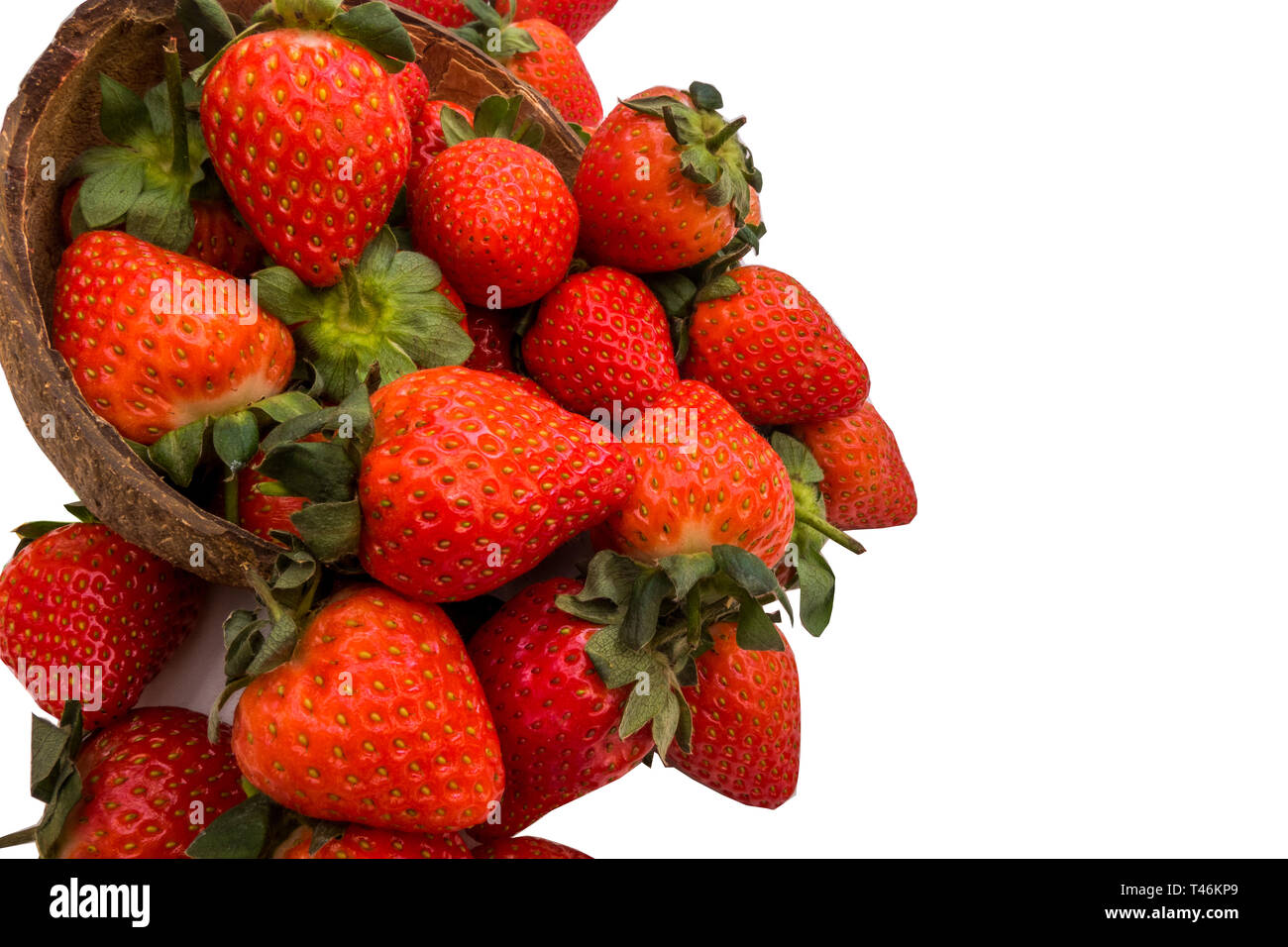 Fresh strawberries in a coconut shell on white background Stock Photo ...