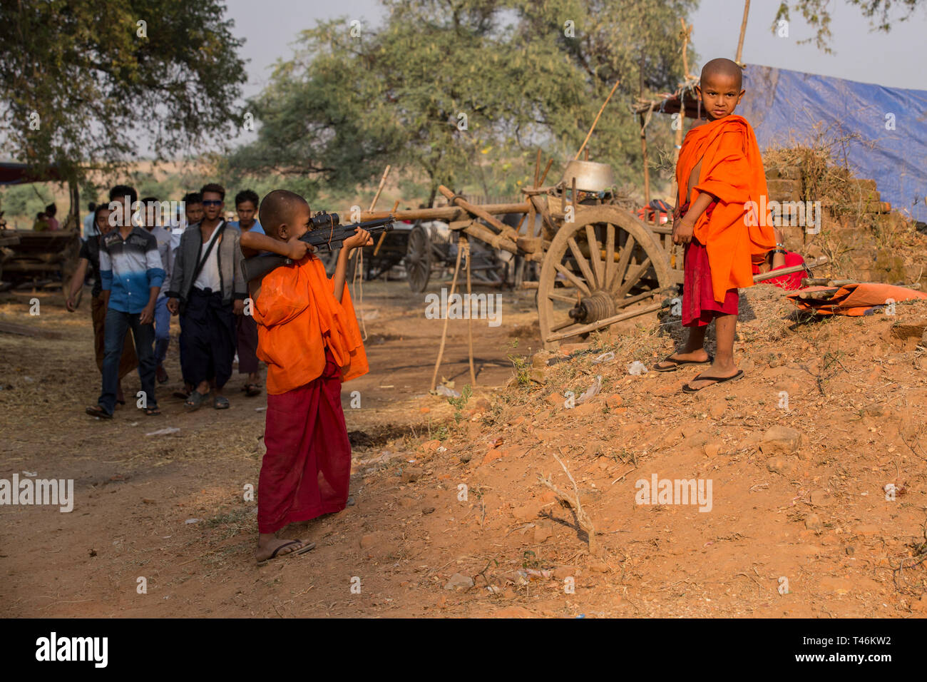 Novice Buddhist monks playing with toy guns at the Vesak full moon ...