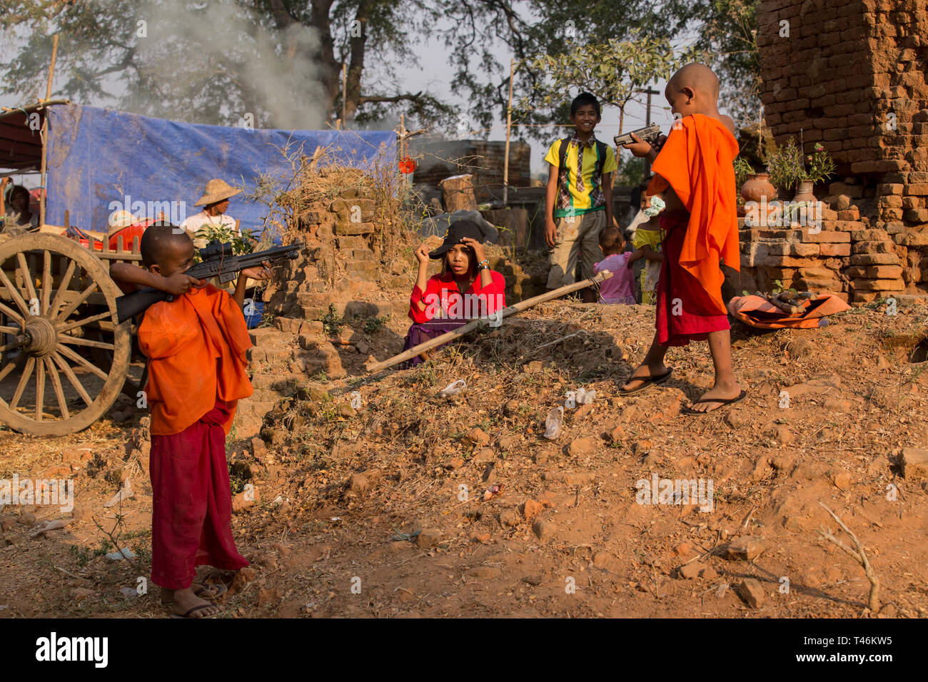 Novice Buddhist monks playing with toy guns at the Vesak full moon ...
