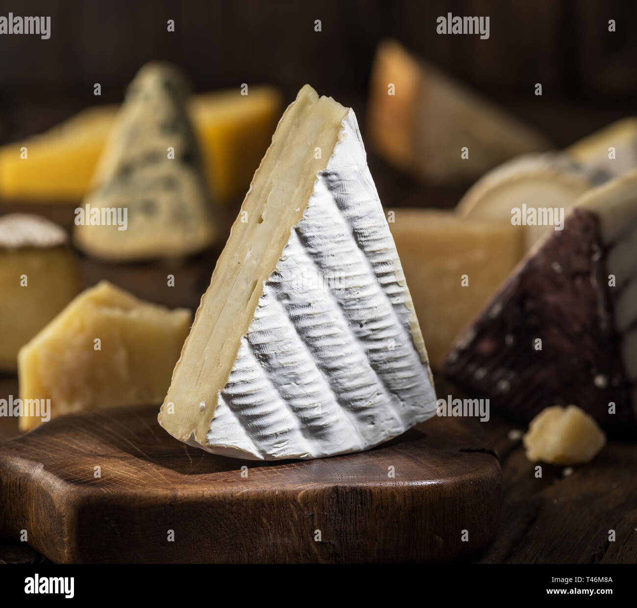 Segment of Brie cheese or soft cow's - milk French cheese on wooden ...