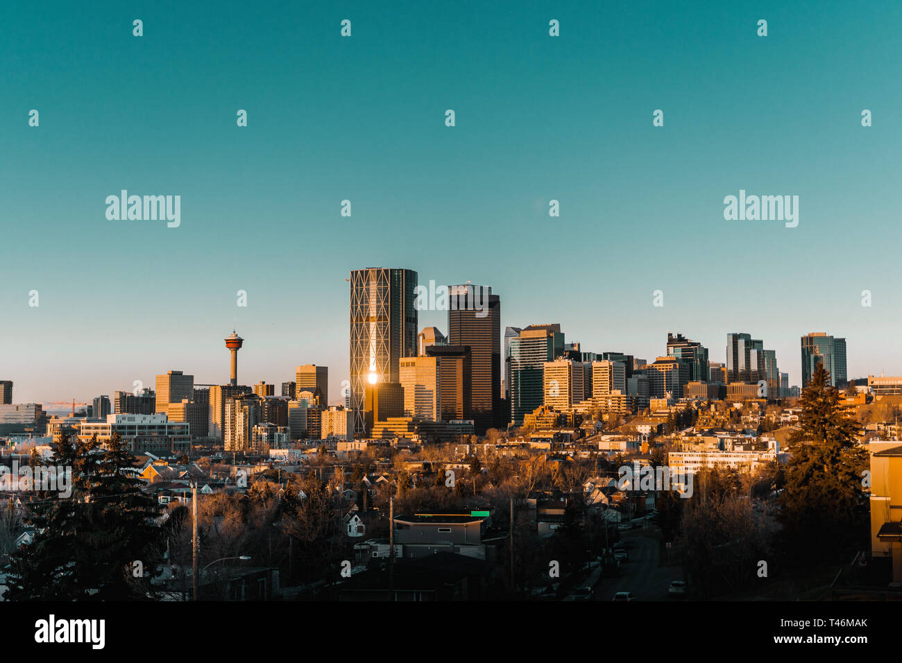Calgary skyline in the early morning with rays from rising sun ...