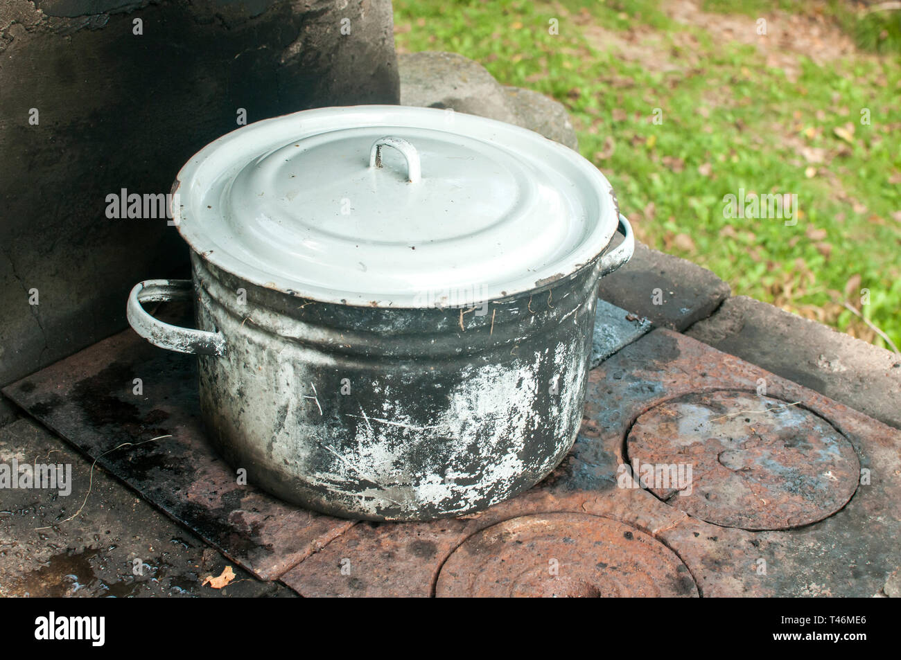 Old vintage grunge metal cooking pots on rural outdoor fireplace Stock ...