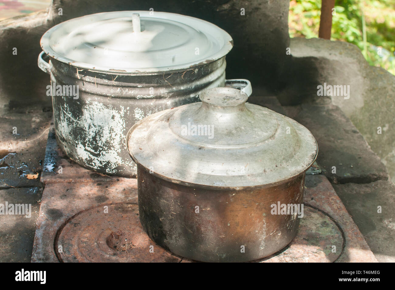 Old vintage grunge metal cooking pots on rural outdoor fireplace Stock ...