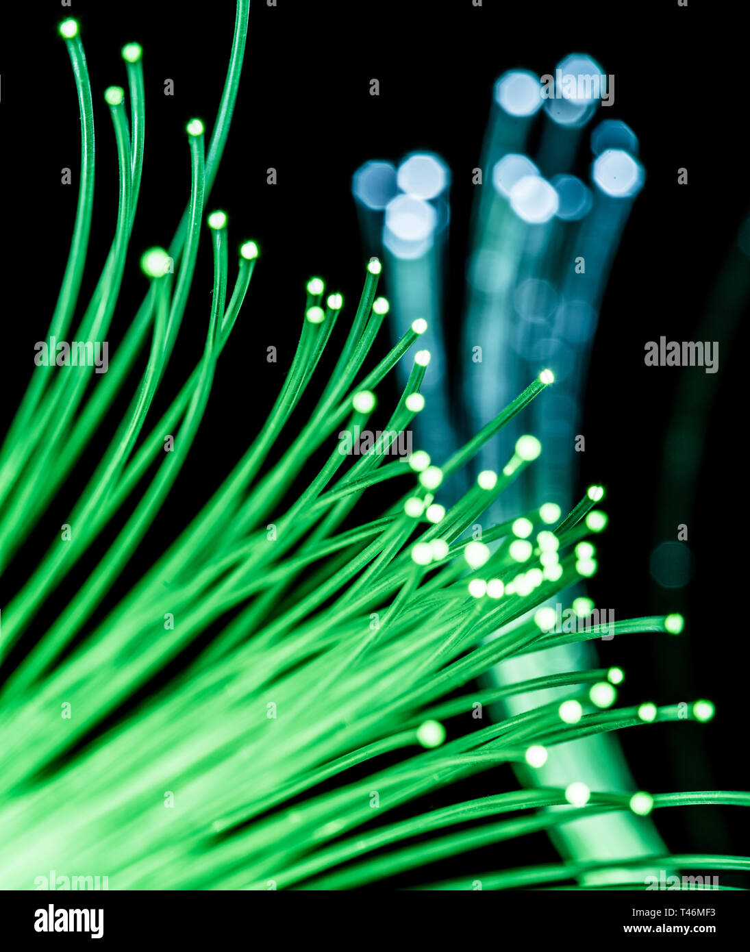 Bundle of optical fibers with green light. Black background Stock Photo ...