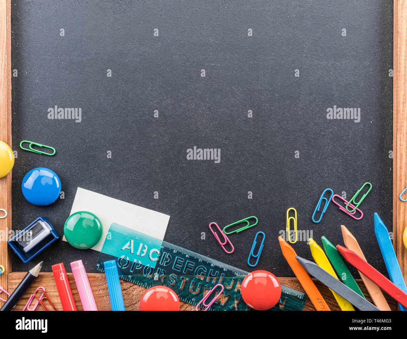 Blackboard and different school things. Close up Stock Photo - Alamy
