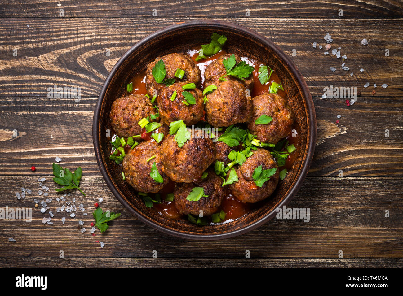 Meatballs in tomato sauce on wooden table top view Stock Photo - Alamy