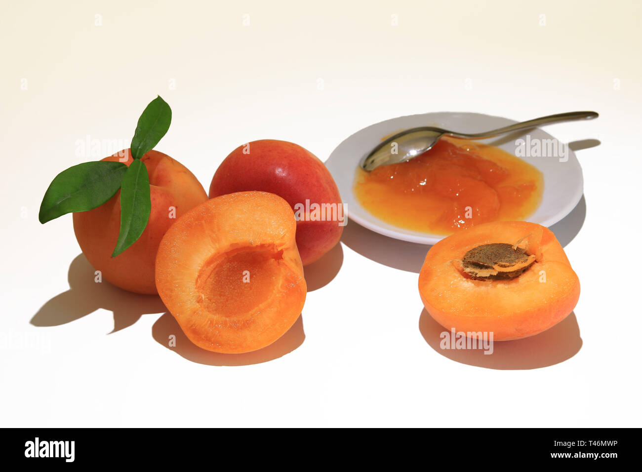 Apricots on white background Stock Photo - Alamy