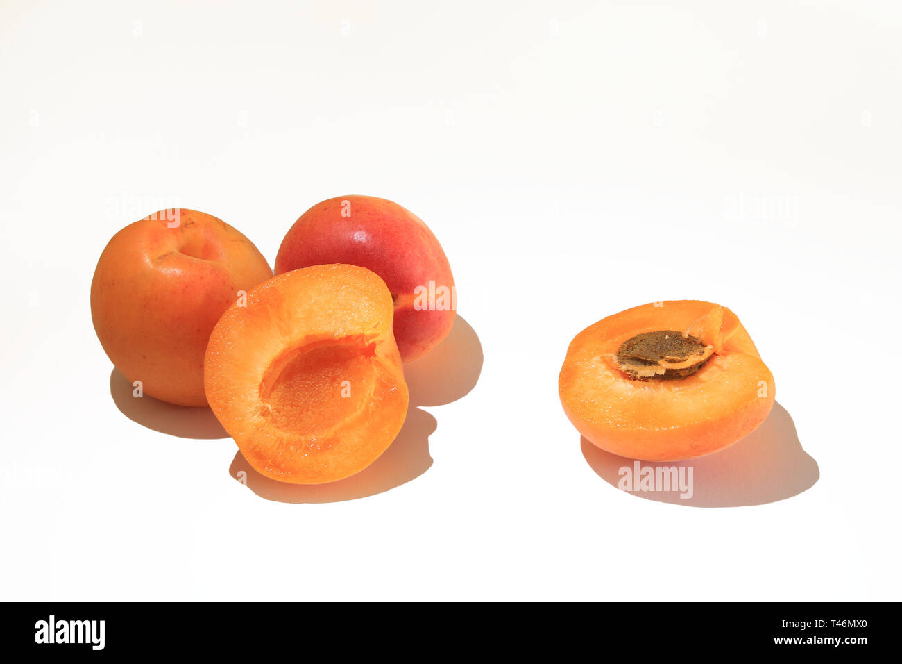 Apricots on white background Stock Photo - Alamy