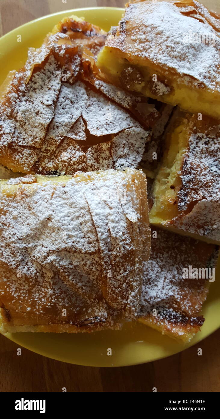 Traditional greek cuisine. Bougatsa, phyllo pastry filled with cream ...