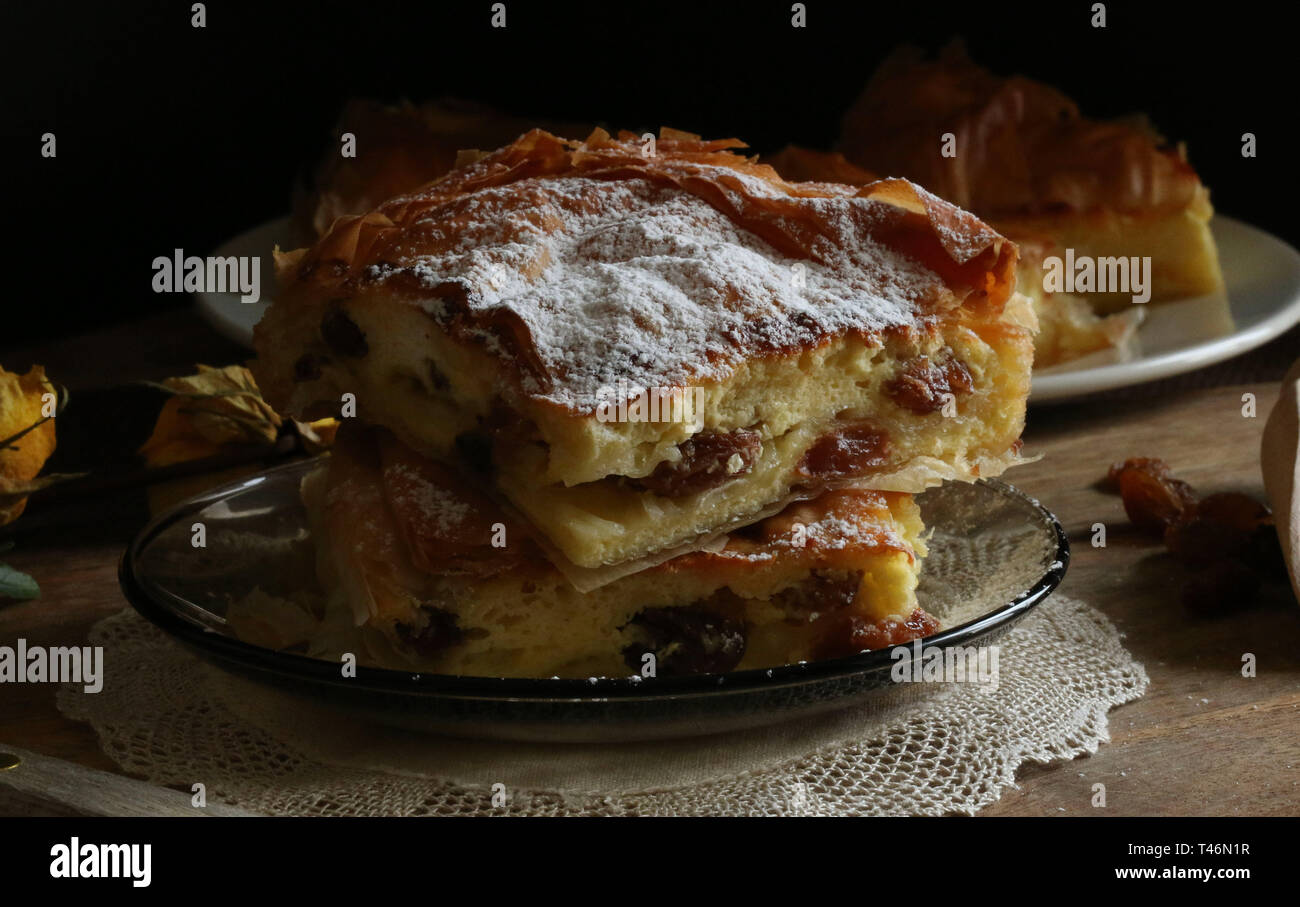 Traditional greek cuisine. Bougatsa, phyllo pastry filled with cream ...