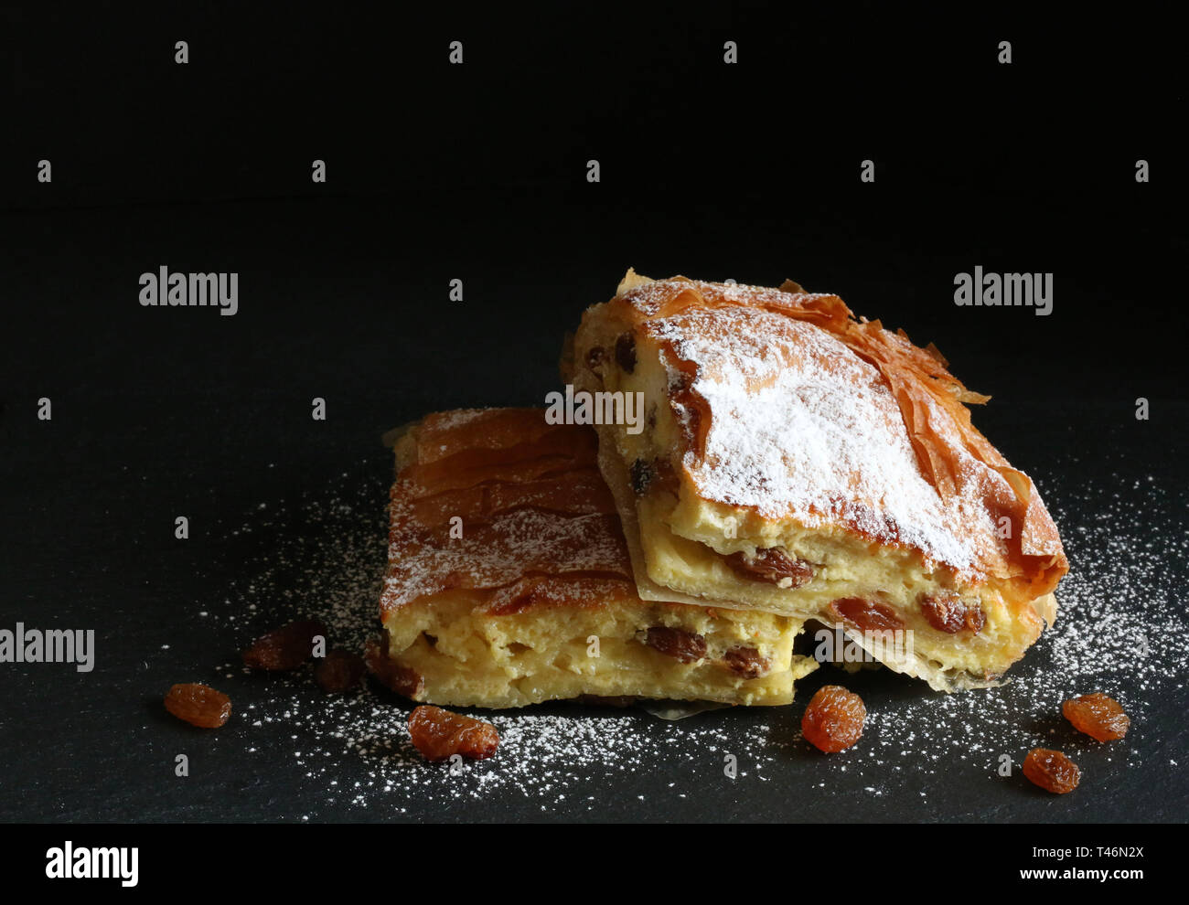 Traditional greek cuisine. Bougatsa, phyllo pastry filled with cream ...