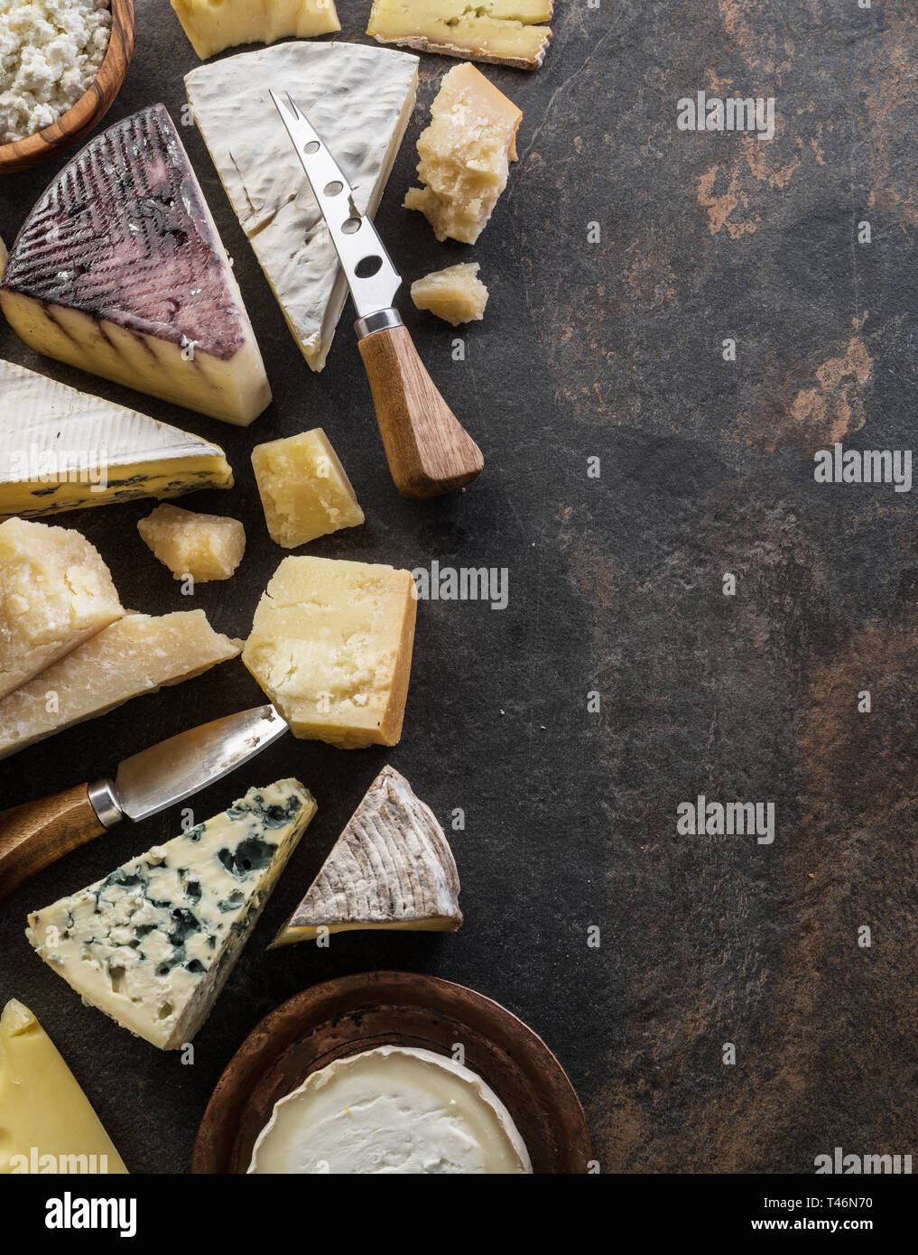 Assortment of organic cheeses on stone background. Top view. Tasty ...