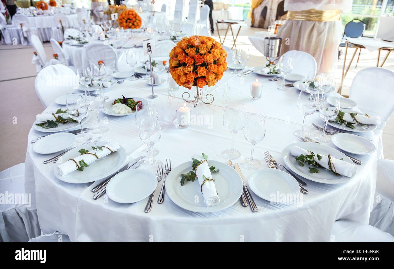 Holiday table setting decorated with flowers and candles Stock Photo ...