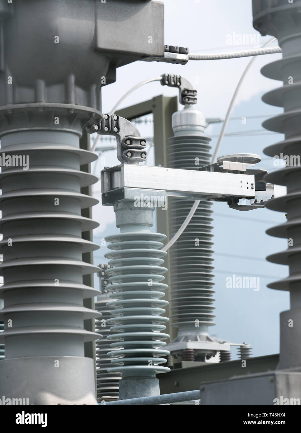 A detail view of transformers and conduits at an electric power station ...