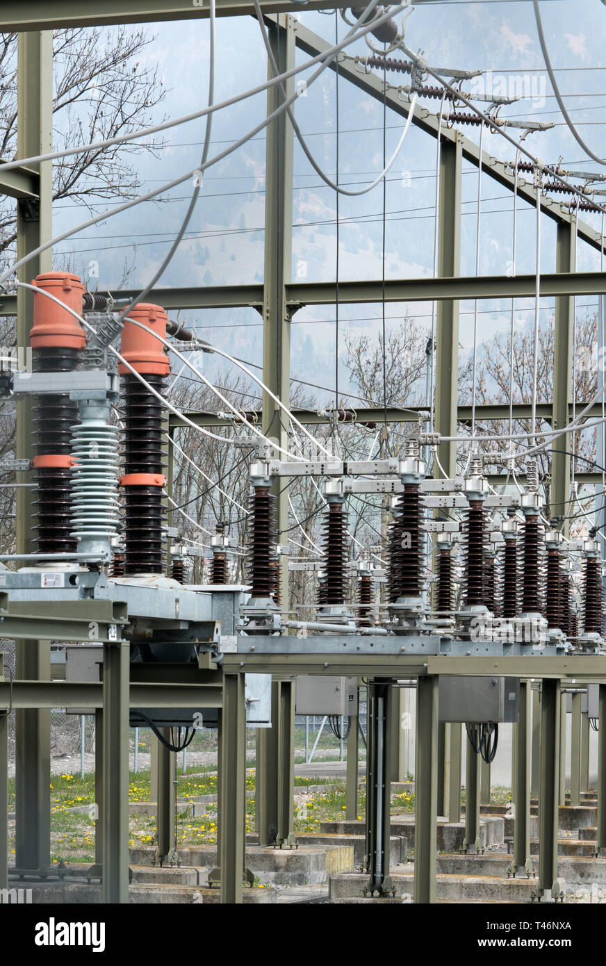A detail view of transformers and conduits at an electric power station ...
