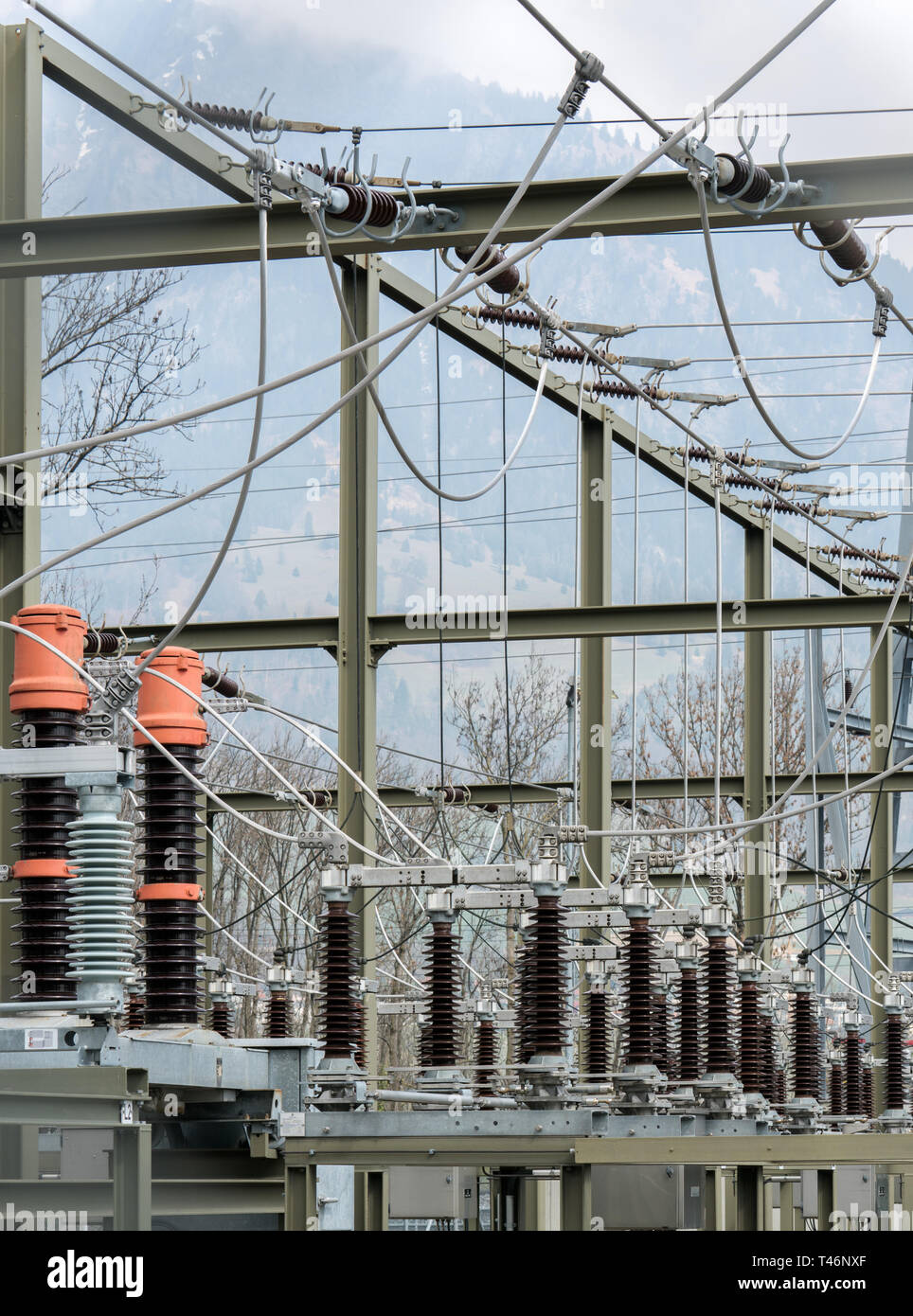 A detail view of transformers and conduits at an electric power station ...